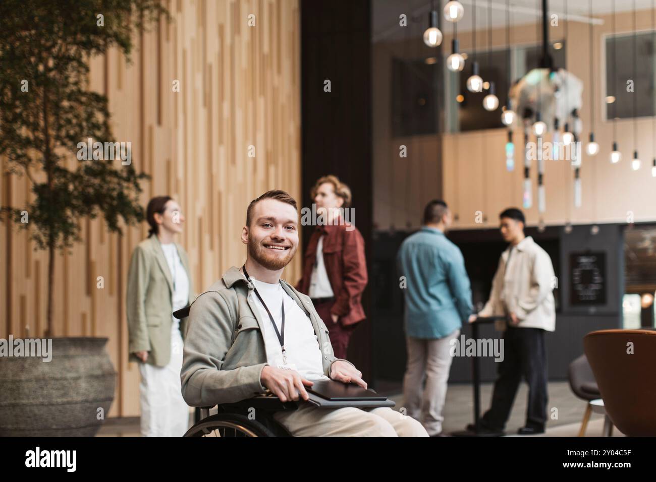Portrait of smiling male entrepreneur with disability sitting on ...