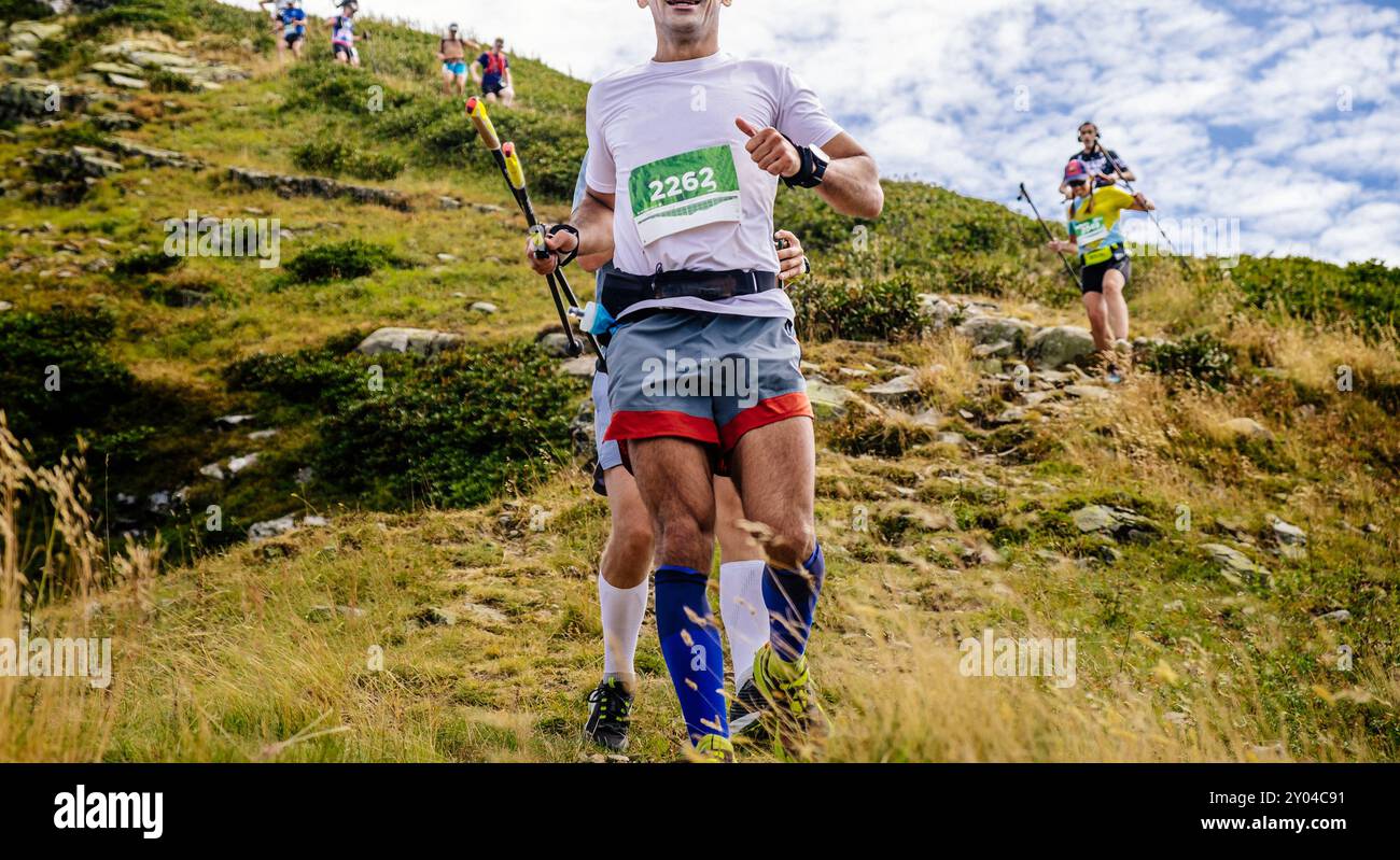 group athletes running steep descent in mountain marathon race Stock ...