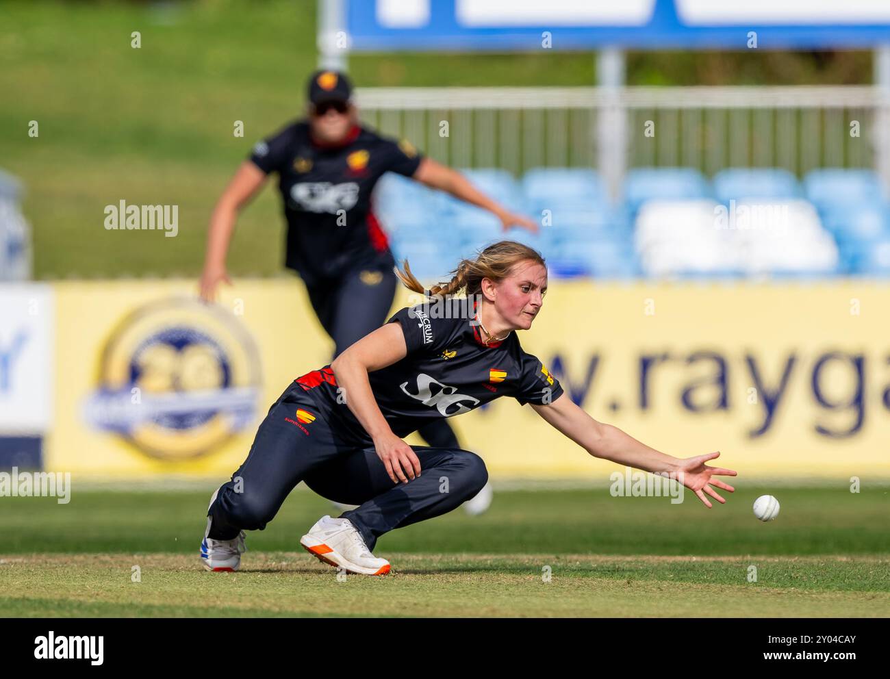 Kate Coppack of Sunrisers fields the ball off her own bowling in a ...