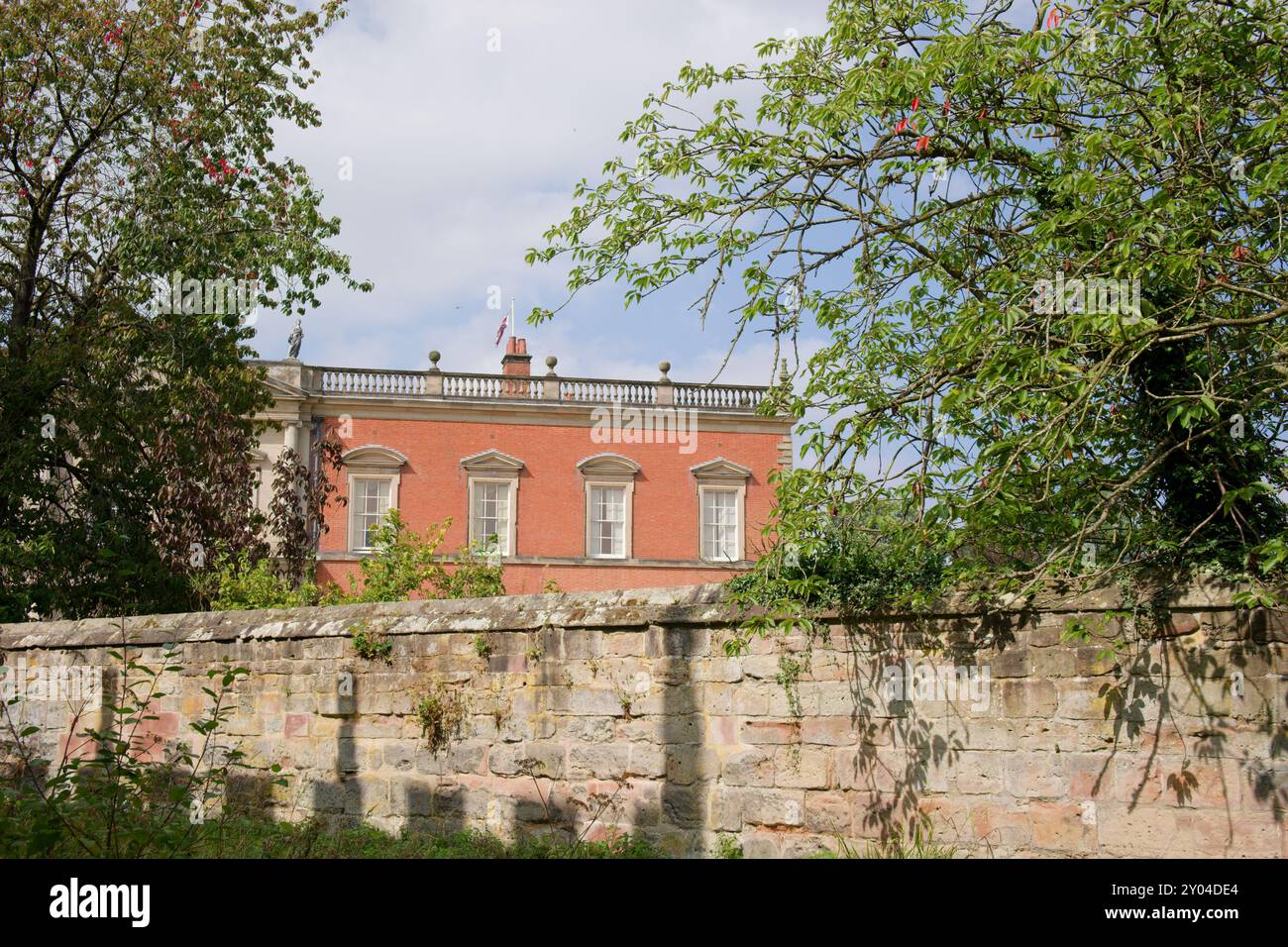 Country house behind a tall stone wall Stock Photo - Alamy