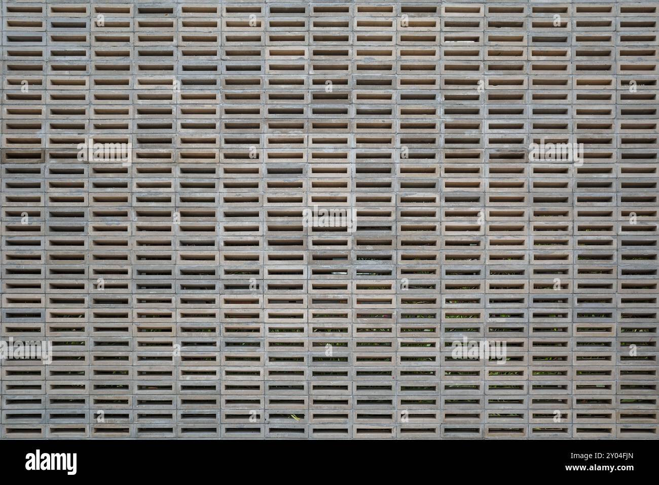 A detailed image of a concrete block wall showcasing a repetitive ...