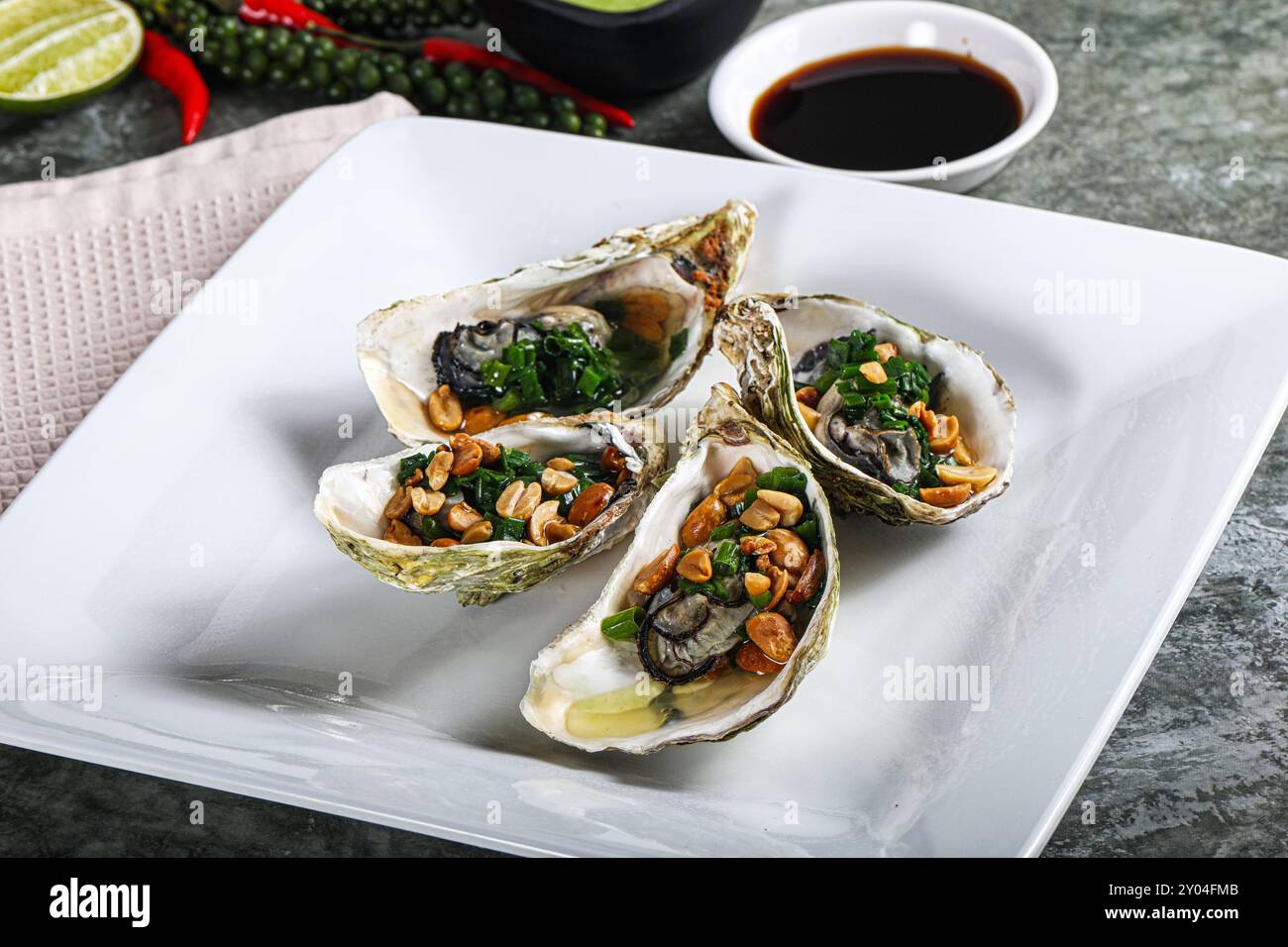 Open half oysters with green onion and peanut Stock Photo - Alamy