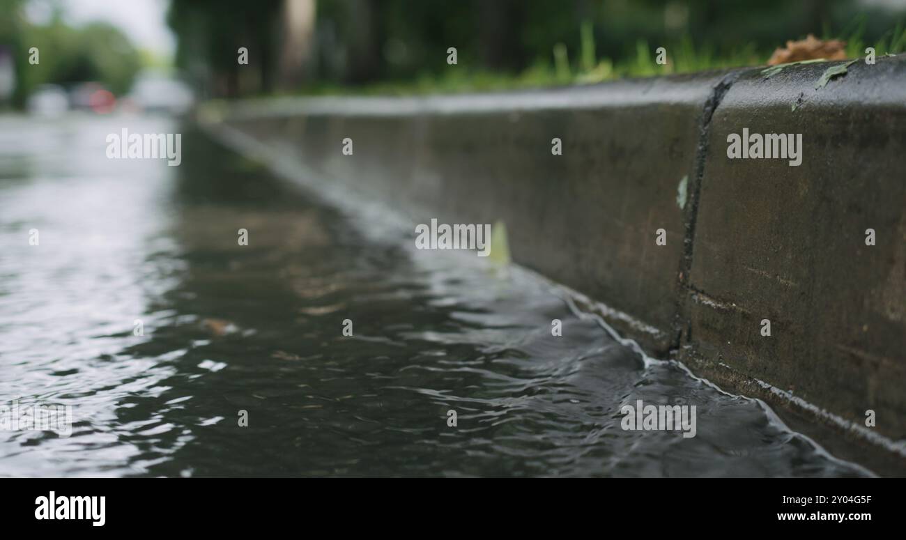 water streams on the street after rain, wide photo Stock Photo - Alamy