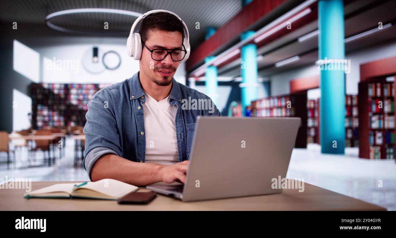 Male Student Studying With Computer Doing Research At Library Stock ...