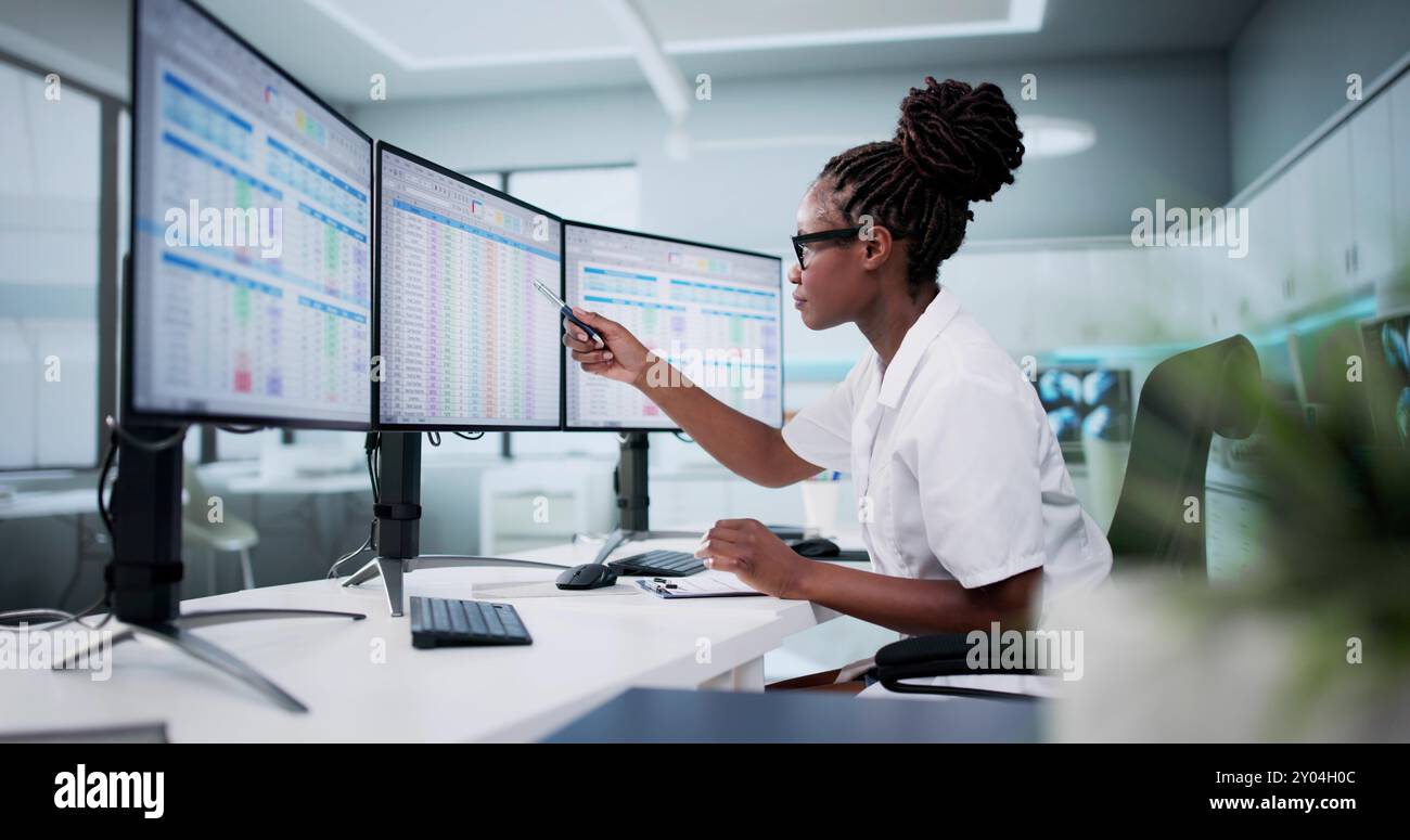 Hospital Doctor Using Spreadsheet For Billing Codes On Desktop Stock ...