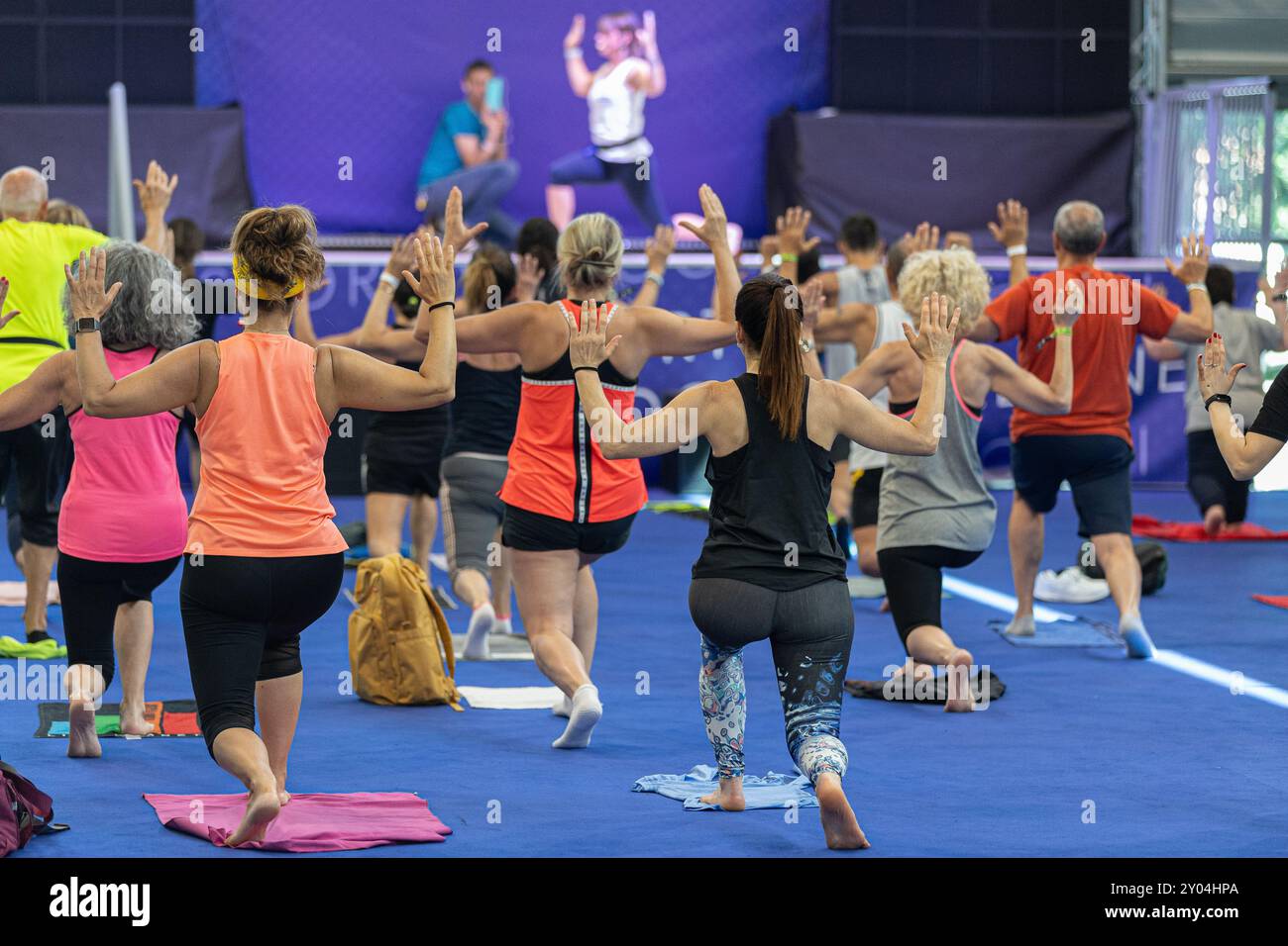 Indoor Fitness Workout - People doing Free Body Exercises wth Teacher ...