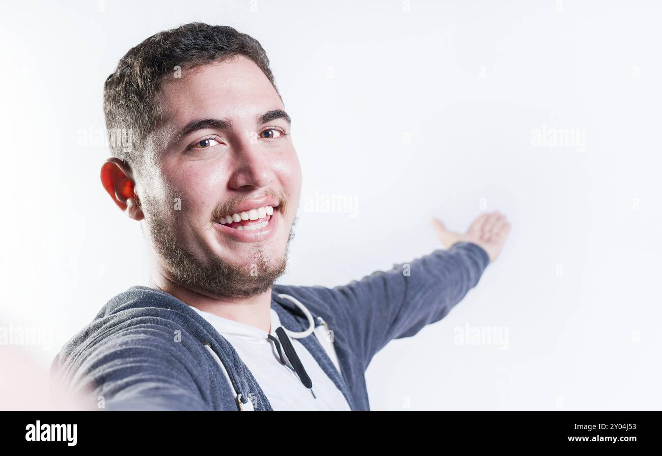 Happy young man welcoming you isolated. Portrait of smiling guy ...