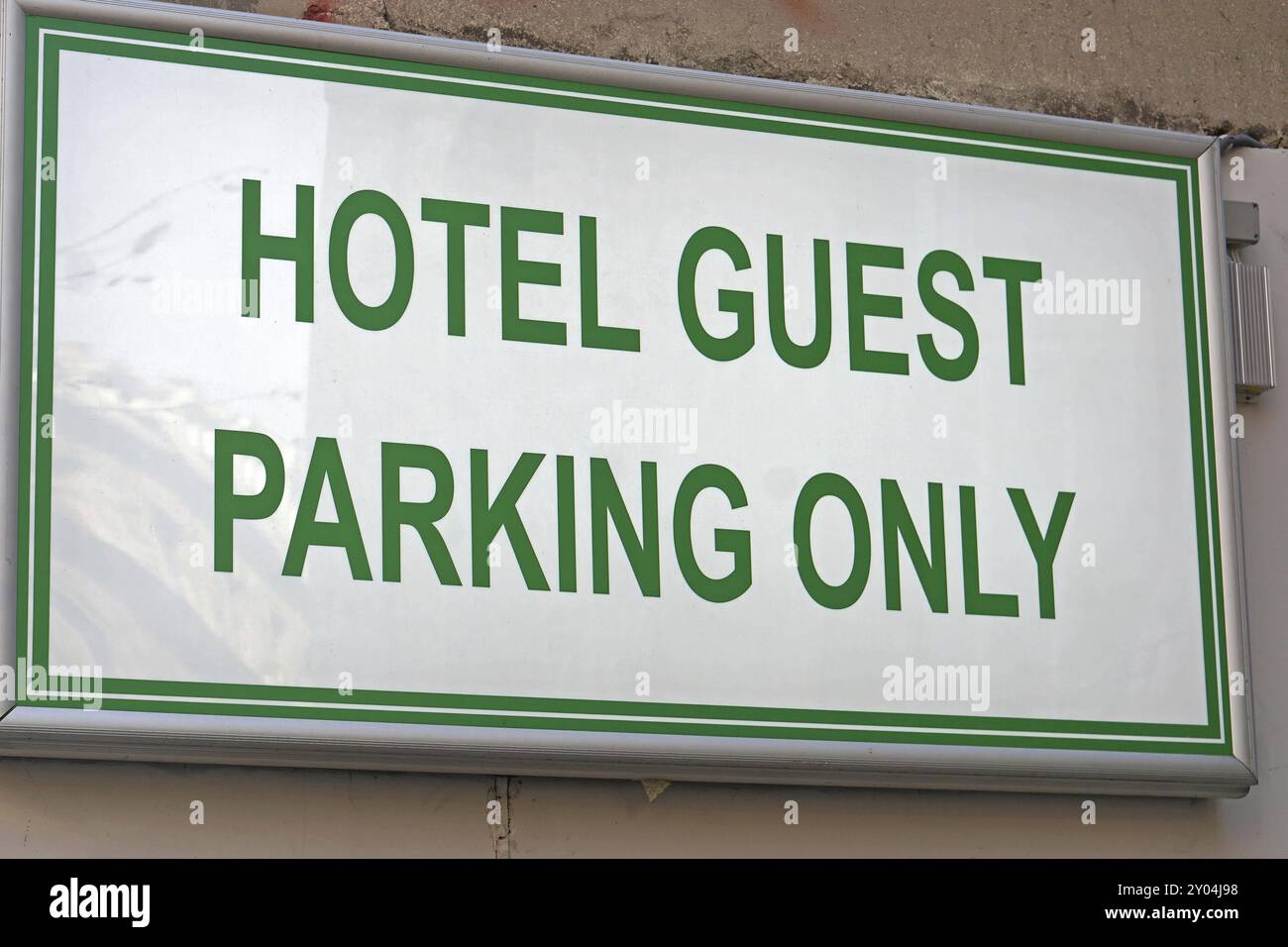 Hotel guest parking only reserved sign board at wall Stock Photo - Alamy