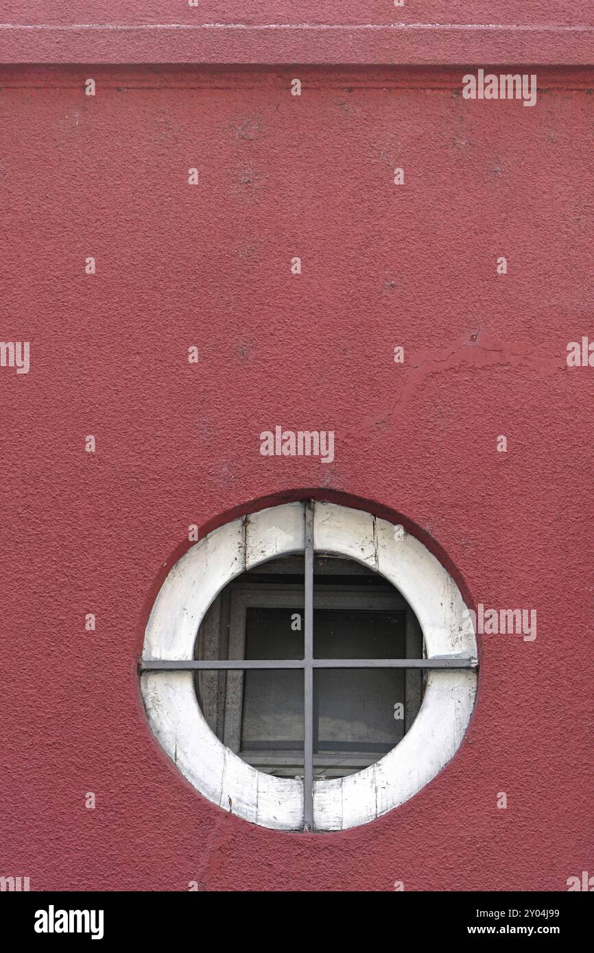 Small round window with security bars cross Stock Photo - Alamy
