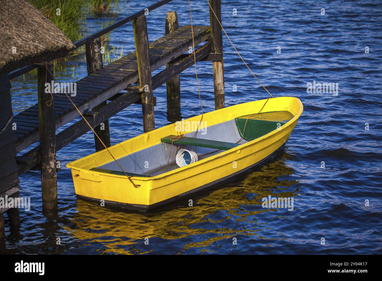 Yellow rowing boat at a landing stage Stock Photo - Alamy