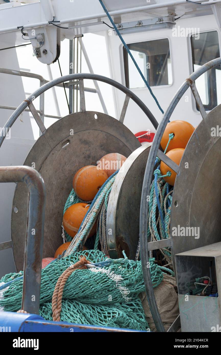 Fishing net on a winch on board a fishing trawler. Fishing net on a ...