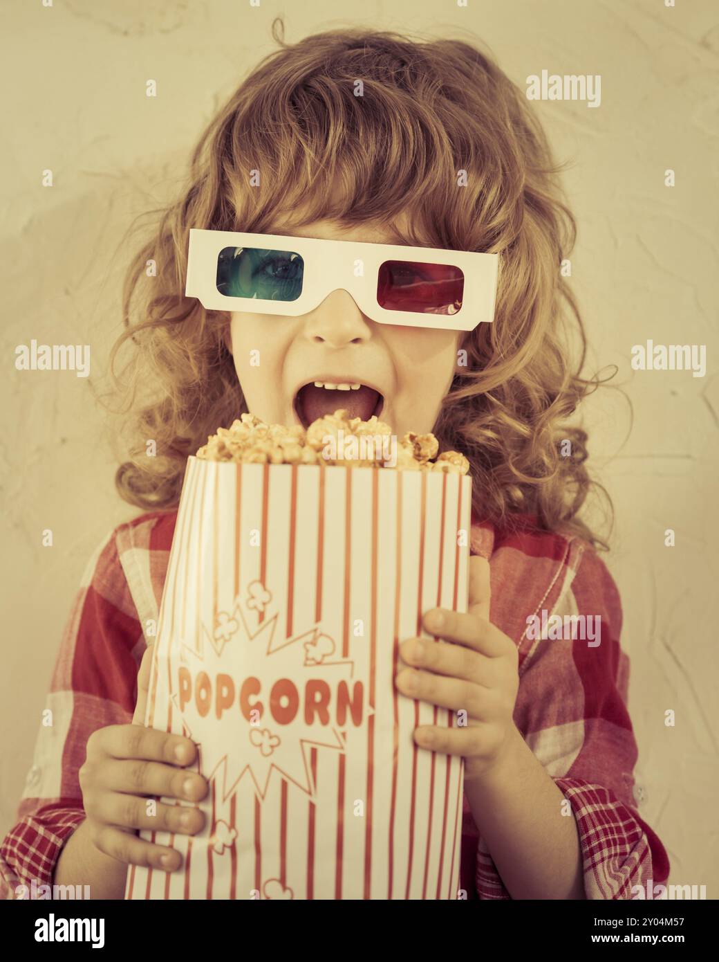 Kid holding popcorn in hands. Cinema concept. Retro style Stock Photo ...