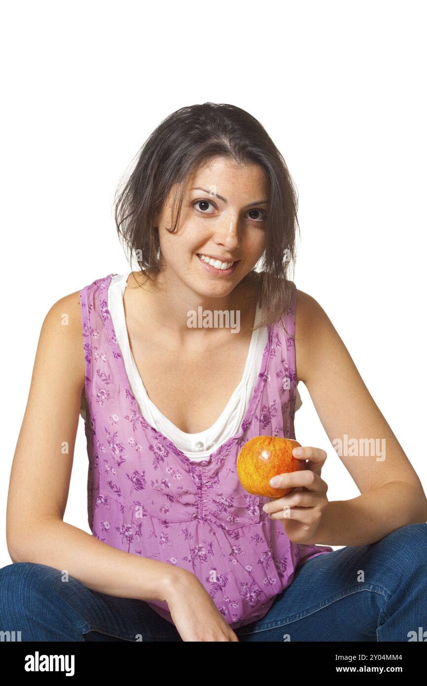 A casually dressed beautiful young lady in jeans sitting open legged ...