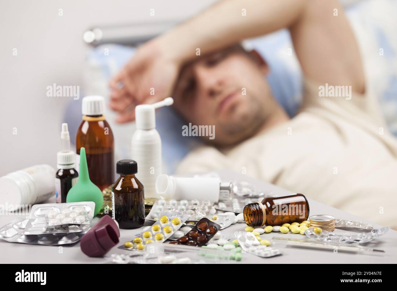 Adult man patient with high temperature lying down bed for cold and flu ...