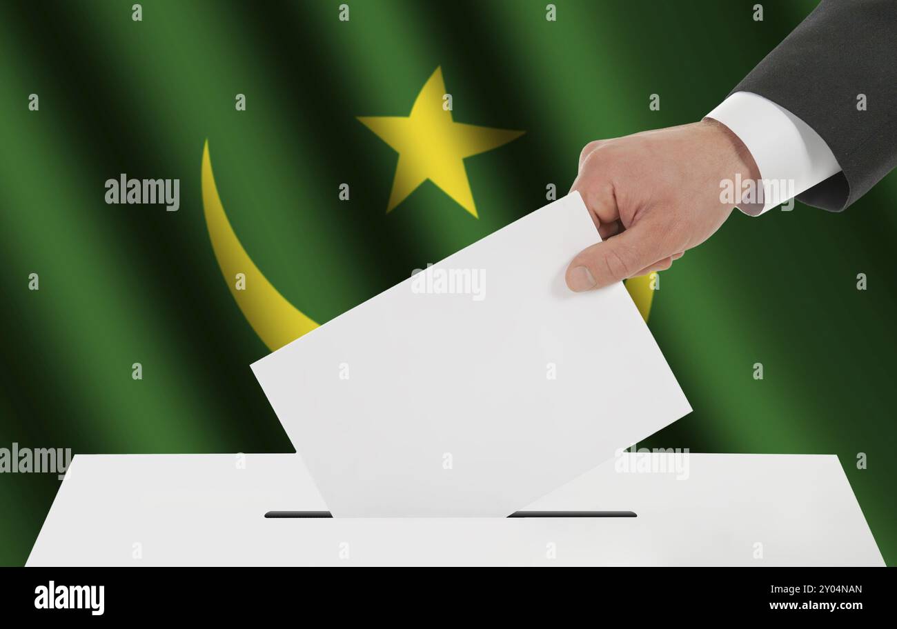 The Mauritania flag and the hand with the bulletin about the ballot box ...