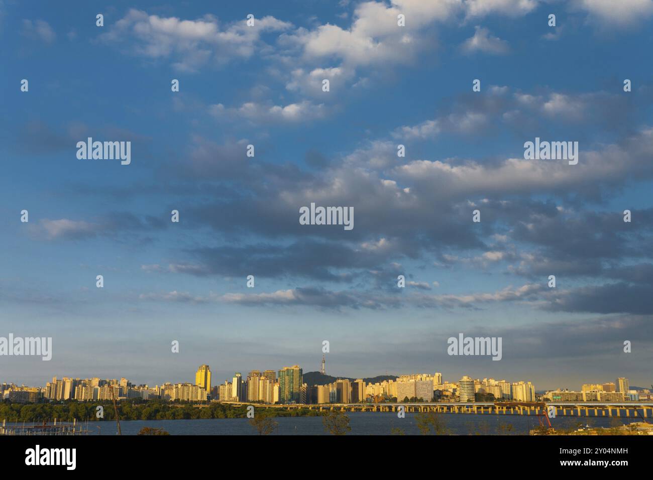 Seoul Tower and city skyline lie next to the Han River in a wide view ...