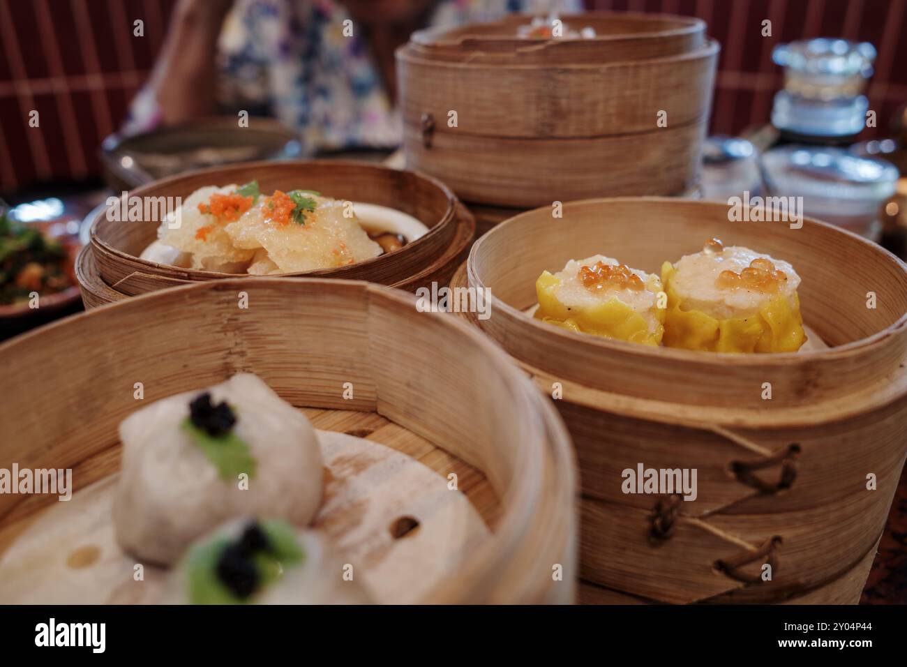 A close-up view of a variety of dim sum dishes served in traditional ...