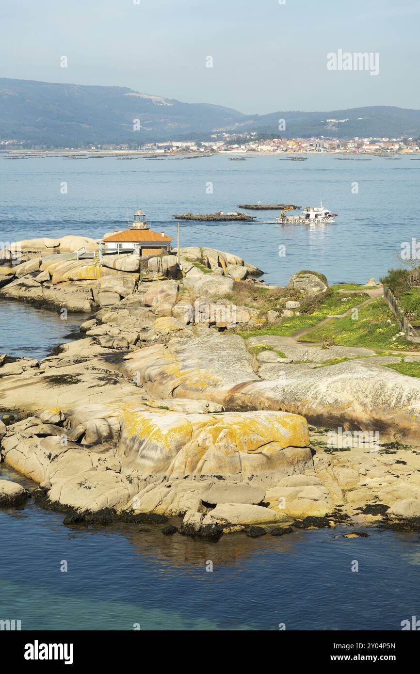 Rias Baixas seascape with Punta Cabalo lighthouse and mussel boat ...