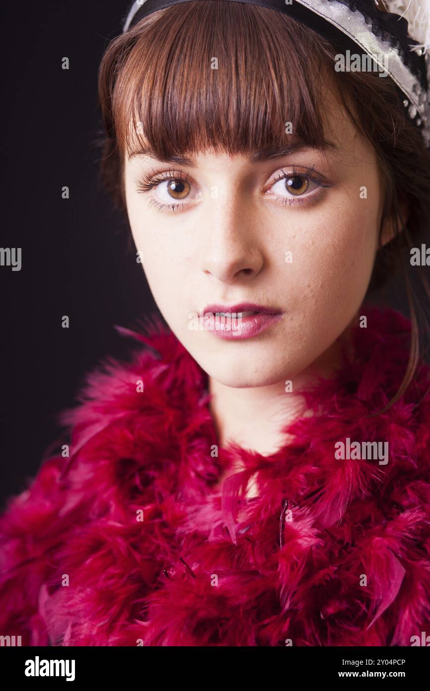 A young woman with feather boa in 20s style the 20s a young woman with ...