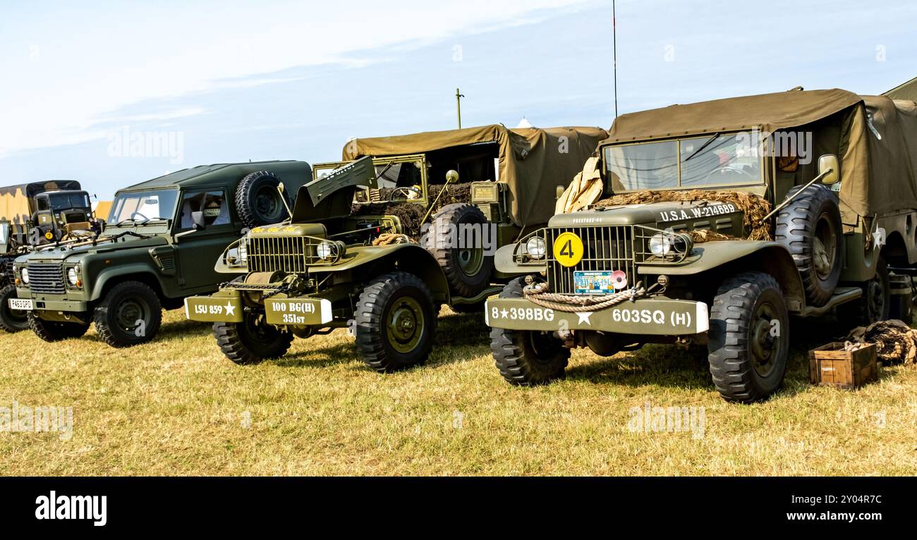 A row of military jeeps and off road vehicles on display at a public ...