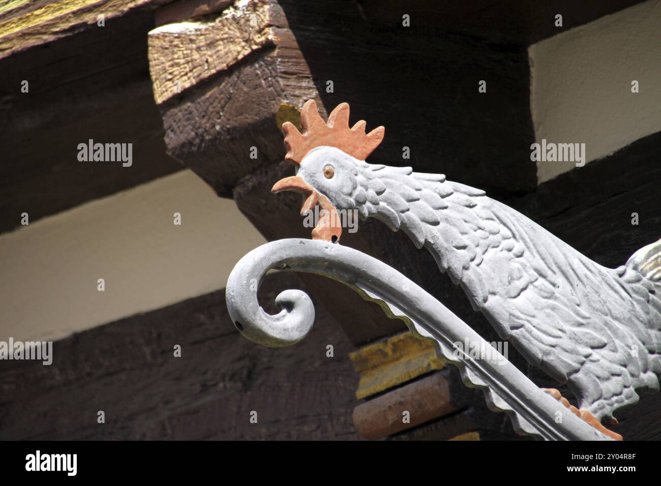 Sign in the shape of a rooster in Rinteln Stock Photo - Alamy
