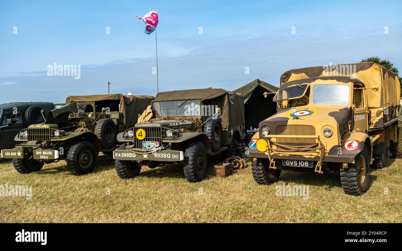 A row of military jeeps and off road vehicles on display at a public ...