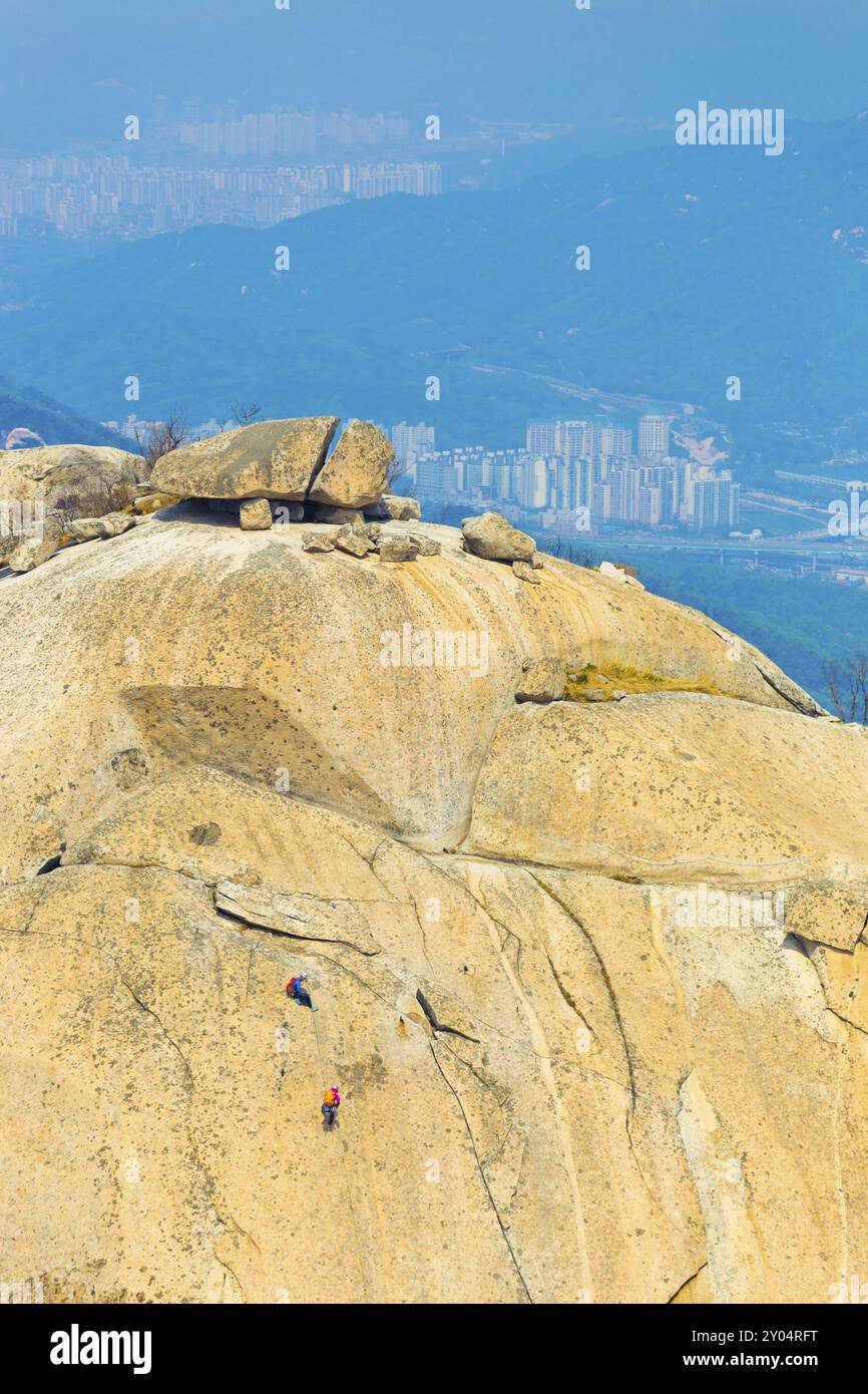 Mountain climbers climbing Insubong peak in Bukhansan mountain with ...