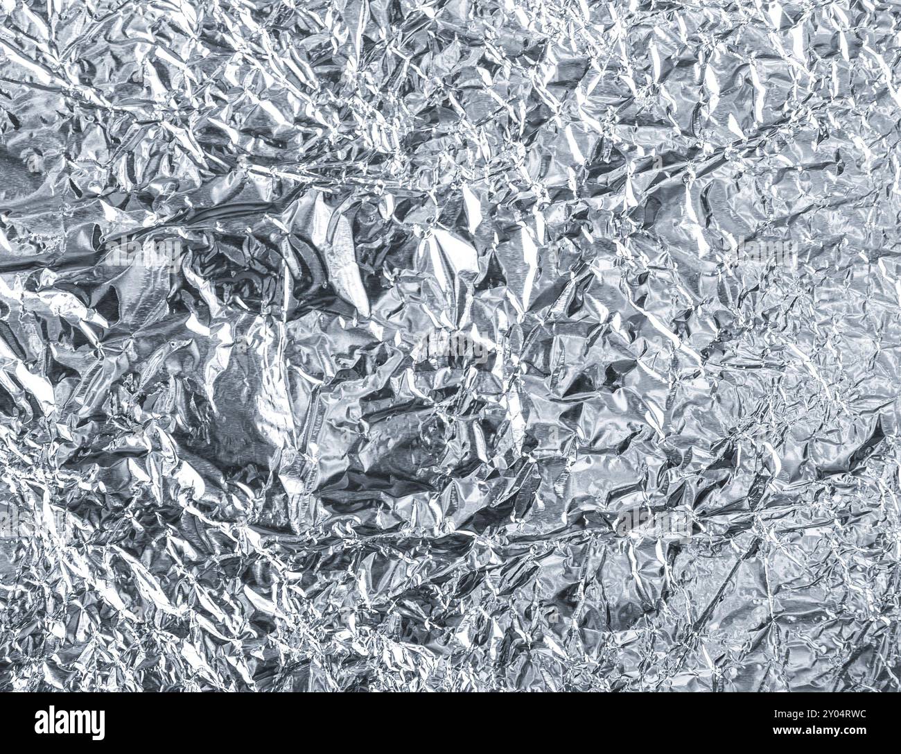 Silver leaf foil background with shiny crumpled uneven surface for texture and background Stock ...