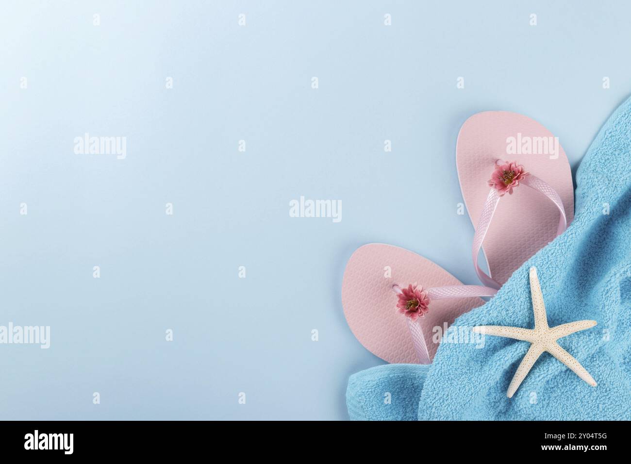 Summer holidays, pink beach slippers flip flops, towel and sea shells ...