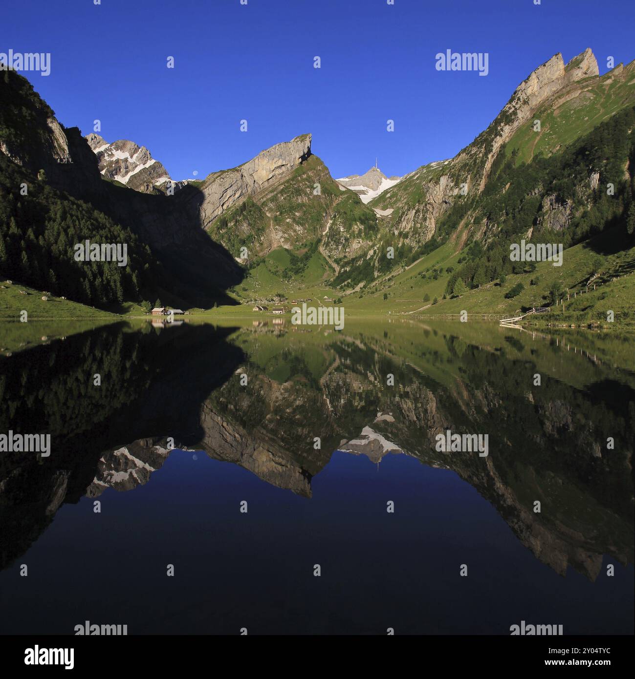 Quiet summer morning at lake Seealpsee. Alpstein Range mirroring on the ...
