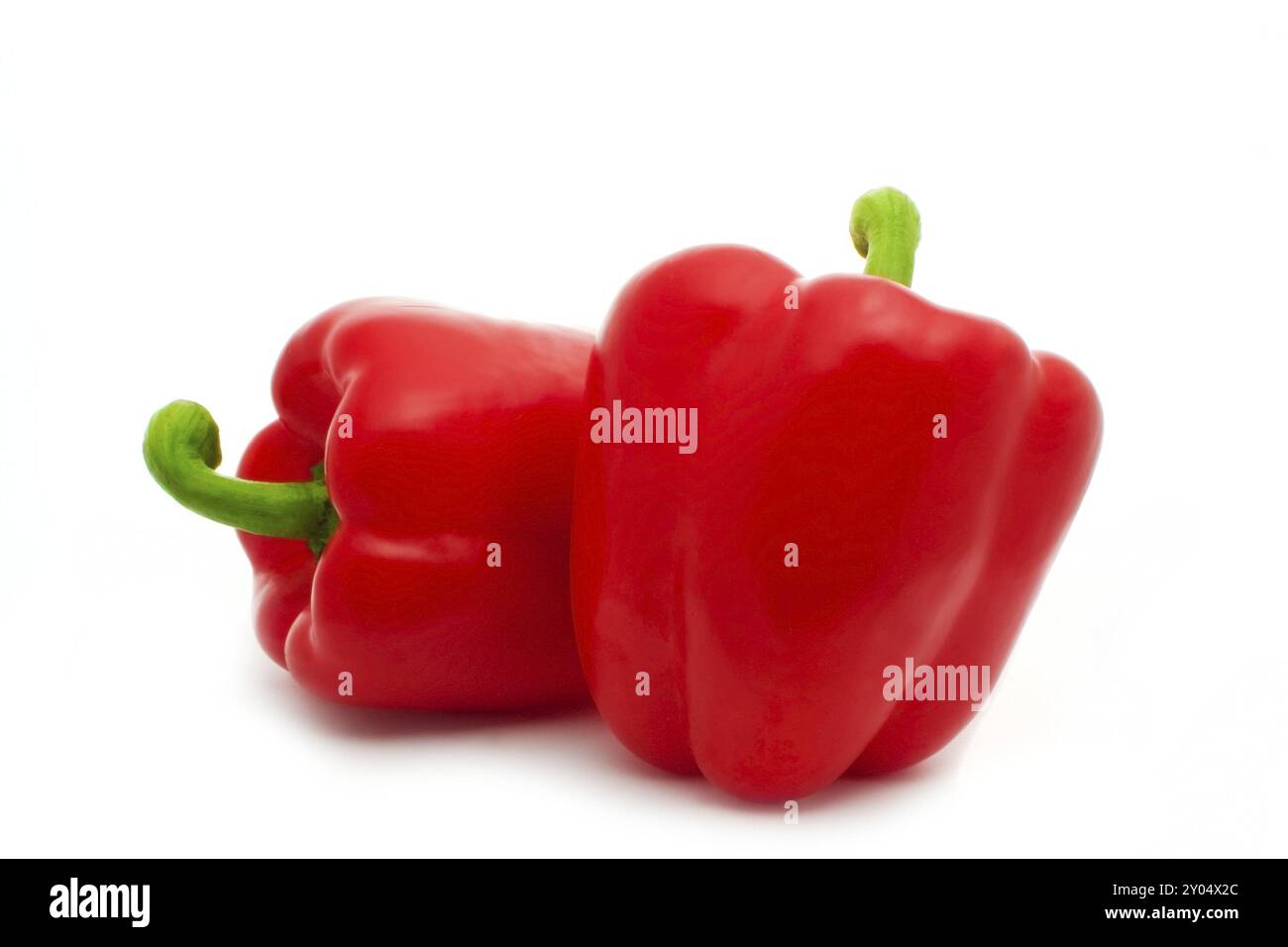 Two fresh red peppers isolated over white Stock Photo - Alamy