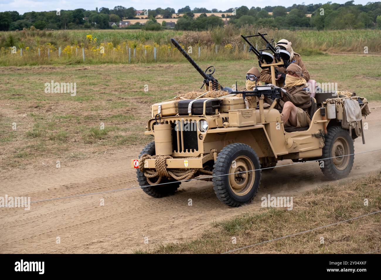 Three men dressed as soldiers in a military off road jeep used in ...