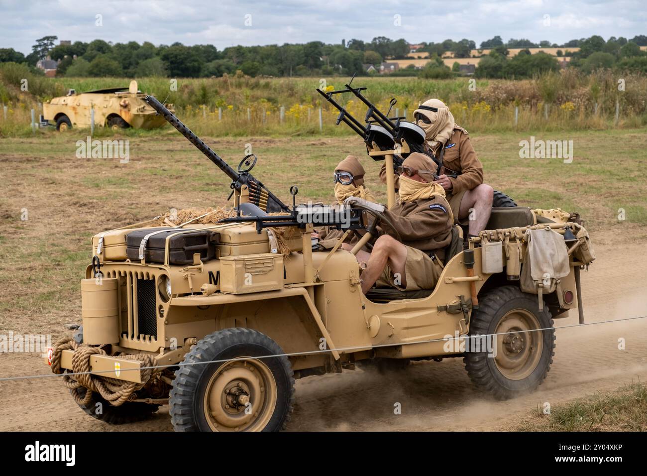 Three men dressed as soldiers in a military off road jeep used in ...