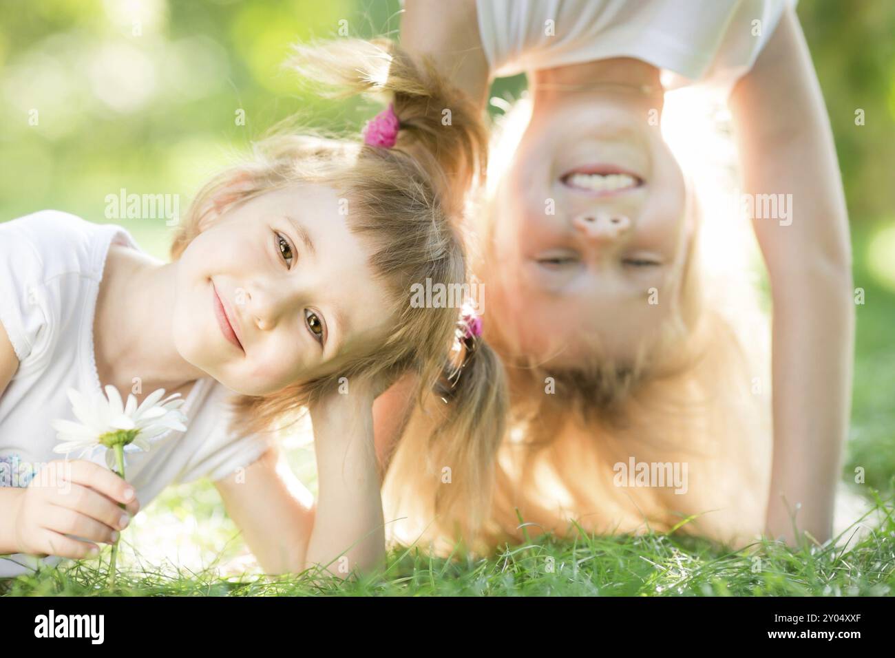 Happy children playing outdoors in spring park Stock Photo - Alamy