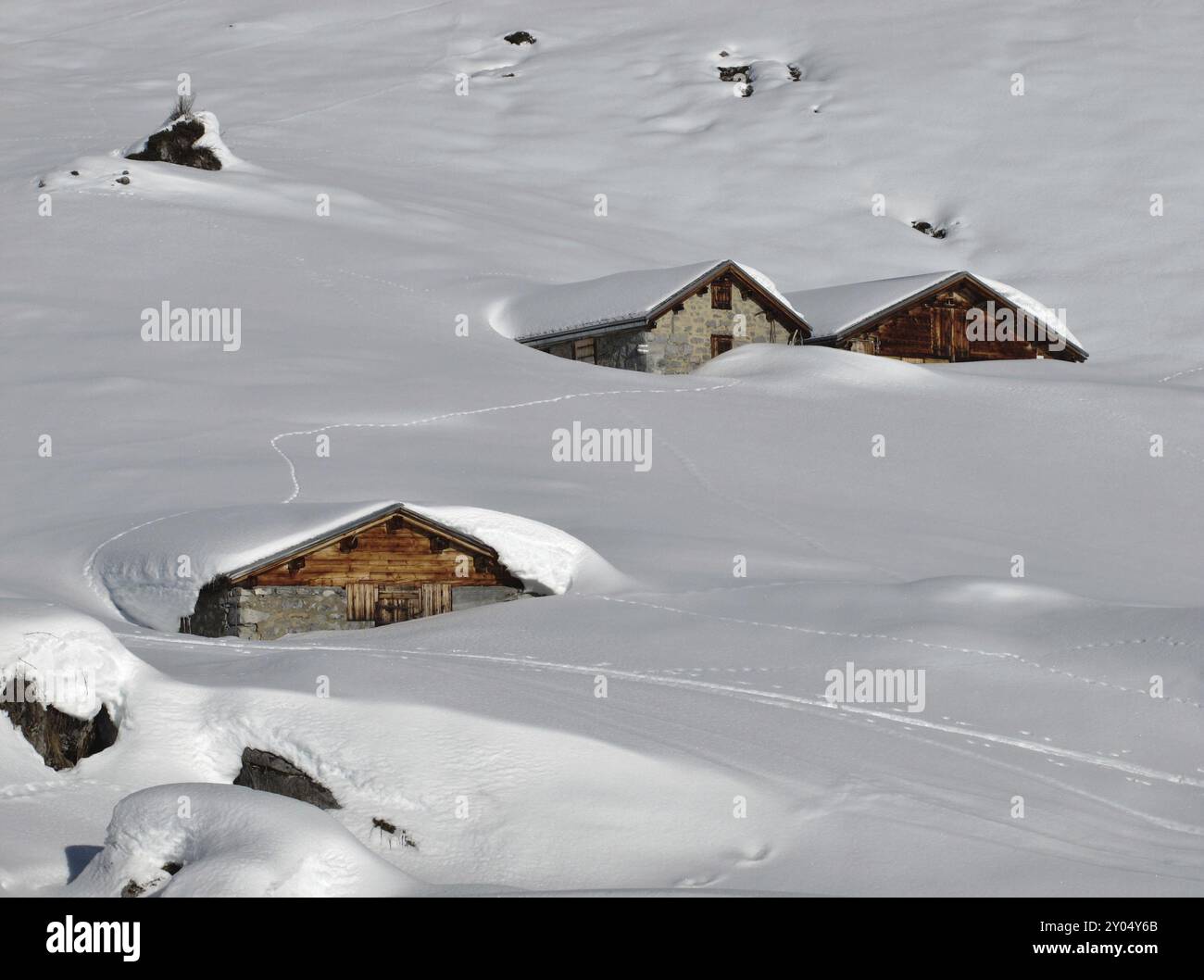 Snow covered huts in the Swiss Alps Stock Photo - Alamy