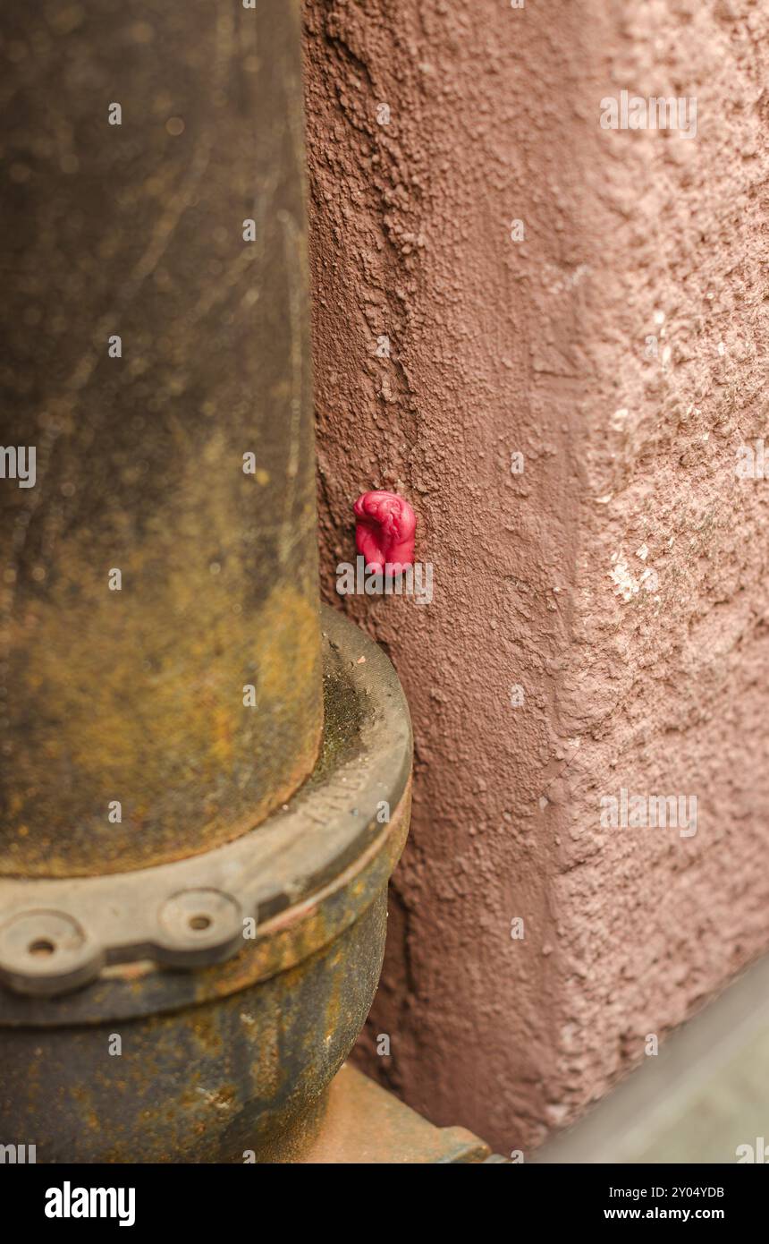used pink gum stuck to light pink wall on street . High quality photo ...