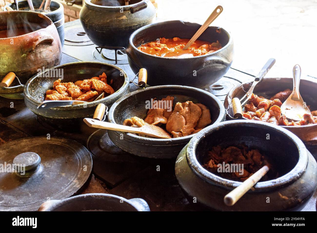Traditional Brazilian food being prepared in clay pots and in the old ...