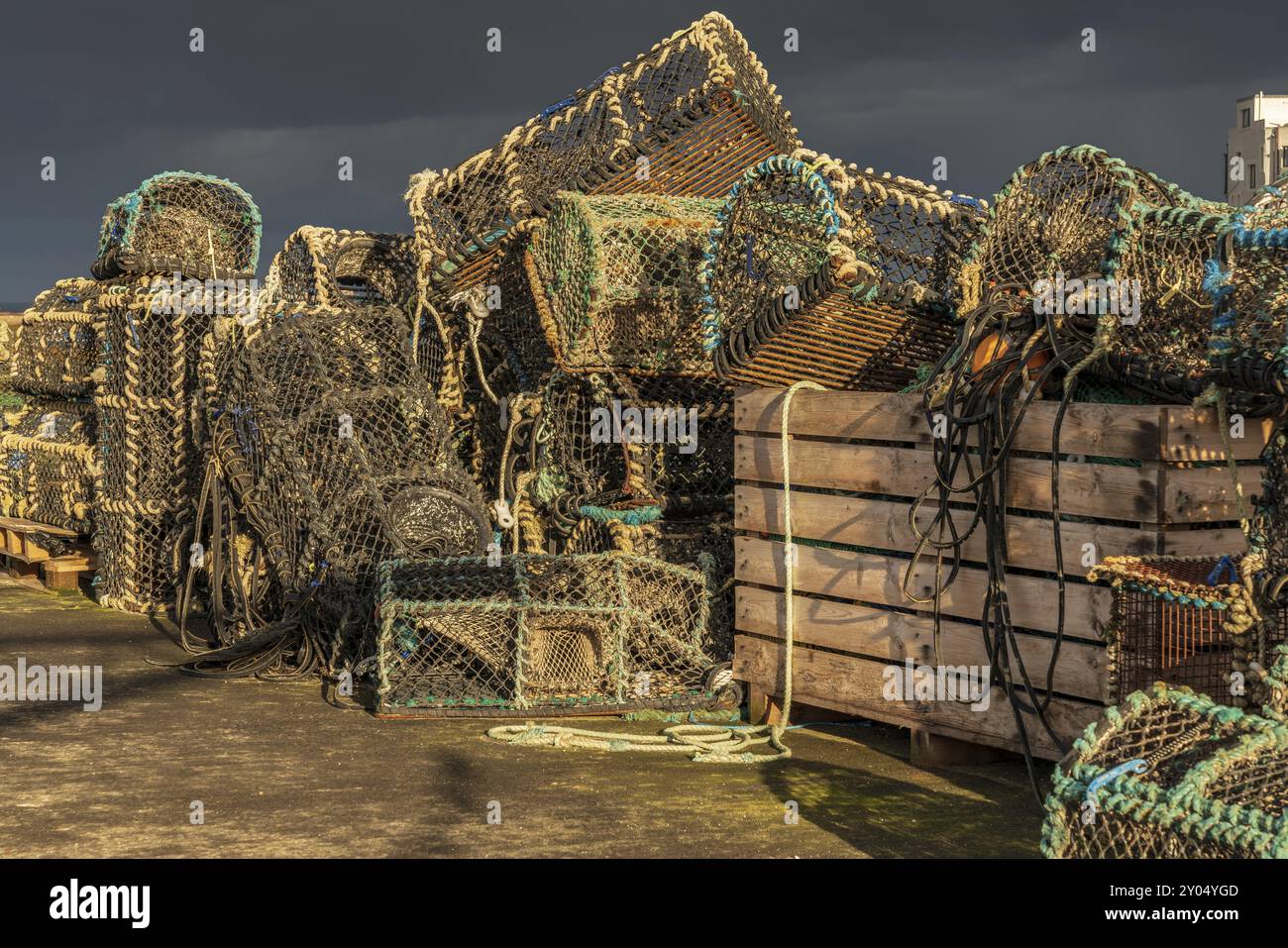 Fish traps in front of dark clouds, seen in Seahouses harbour in ...