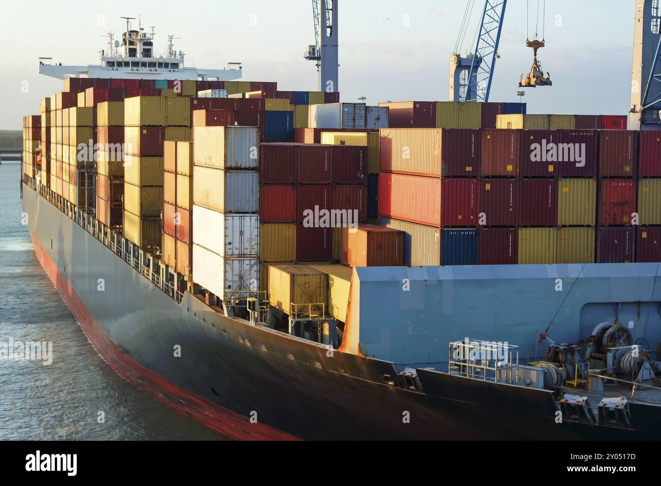 Cargo container ship carrying container under big crane loading cargo ...