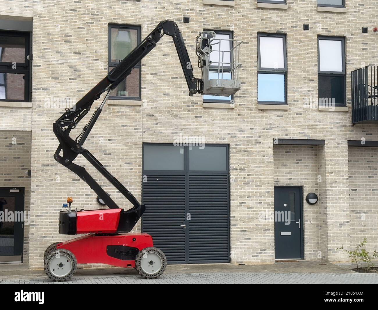 Access platform equipment powered lift at newly completed building Stock Photo - Alamy