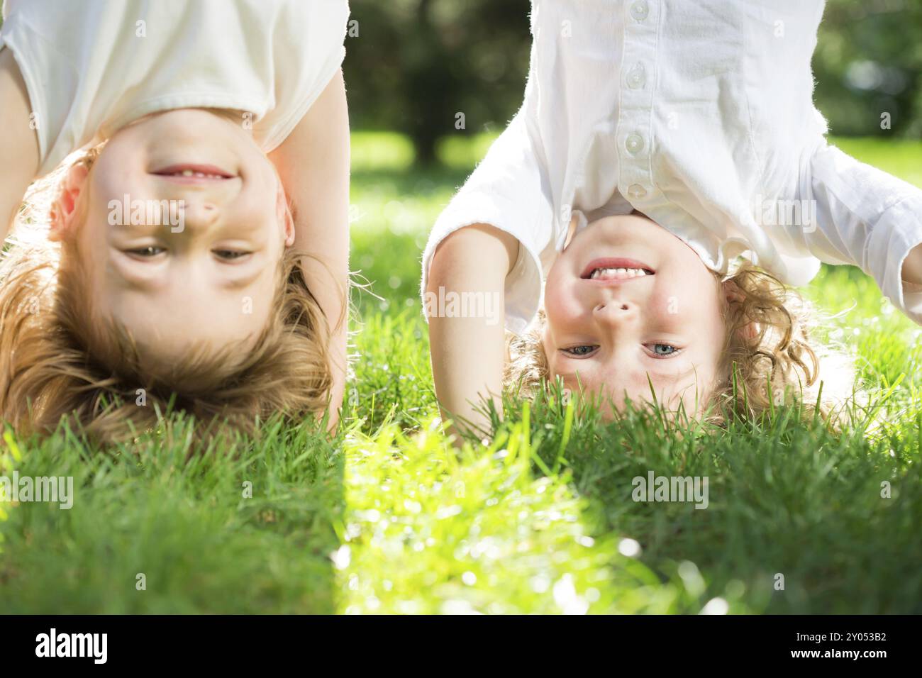 Happy children playing outdoors in spring park Stock Photo - Alamy