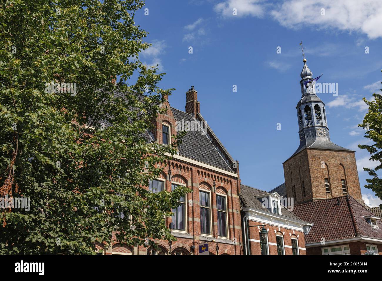 Historic brick buildings and church with striking steeple next to a ...
