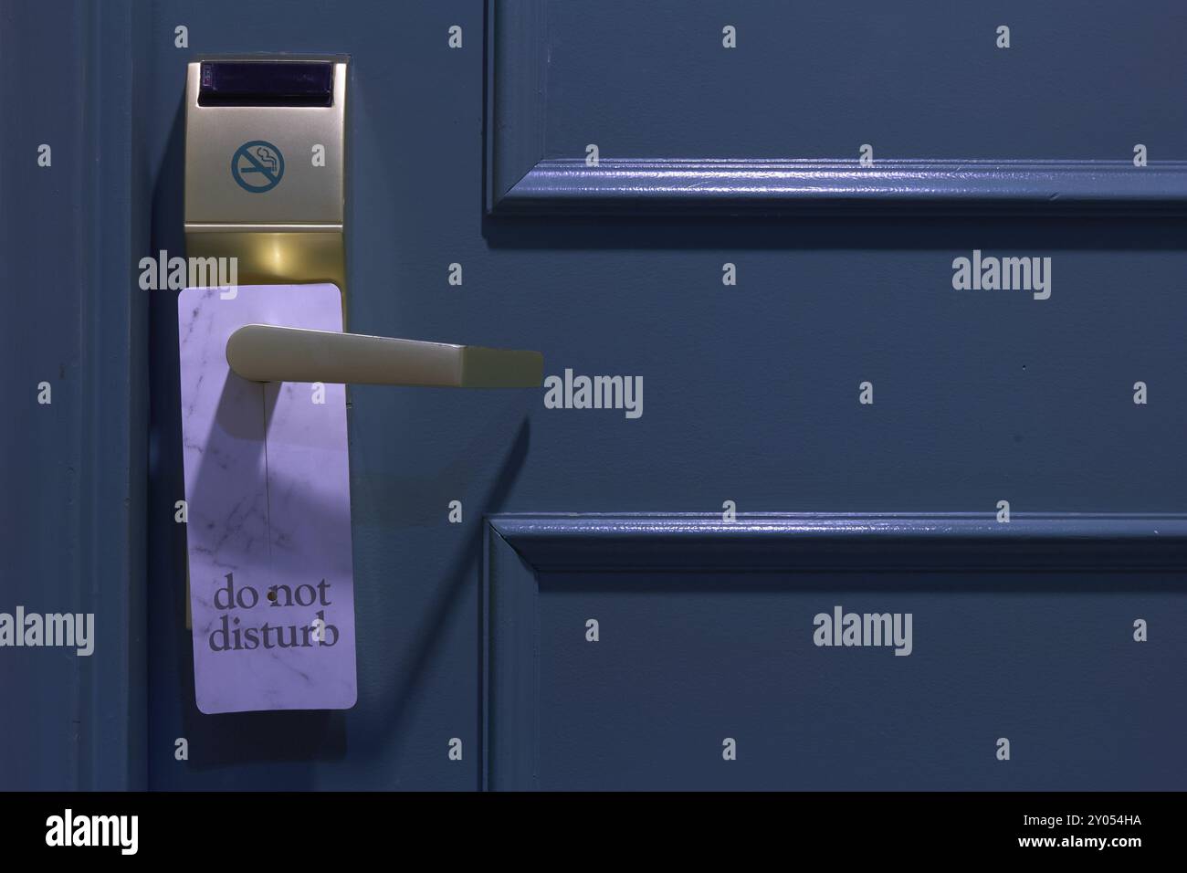 Blue painted door with 'Do Not Disturb' sign and gold-coloured handle ...