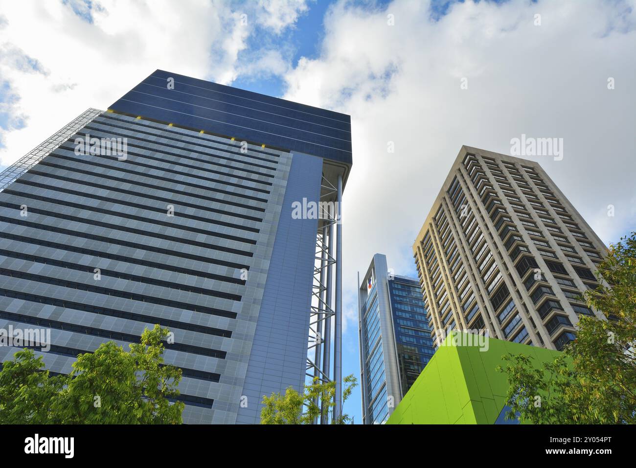 Modern skyscrapers with a backdrop of a blue sky and scattered clouds ...