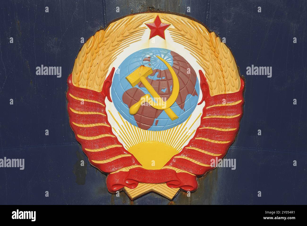 Soviet emblem featuring hammer and sickle over a globe, surrounded by ...