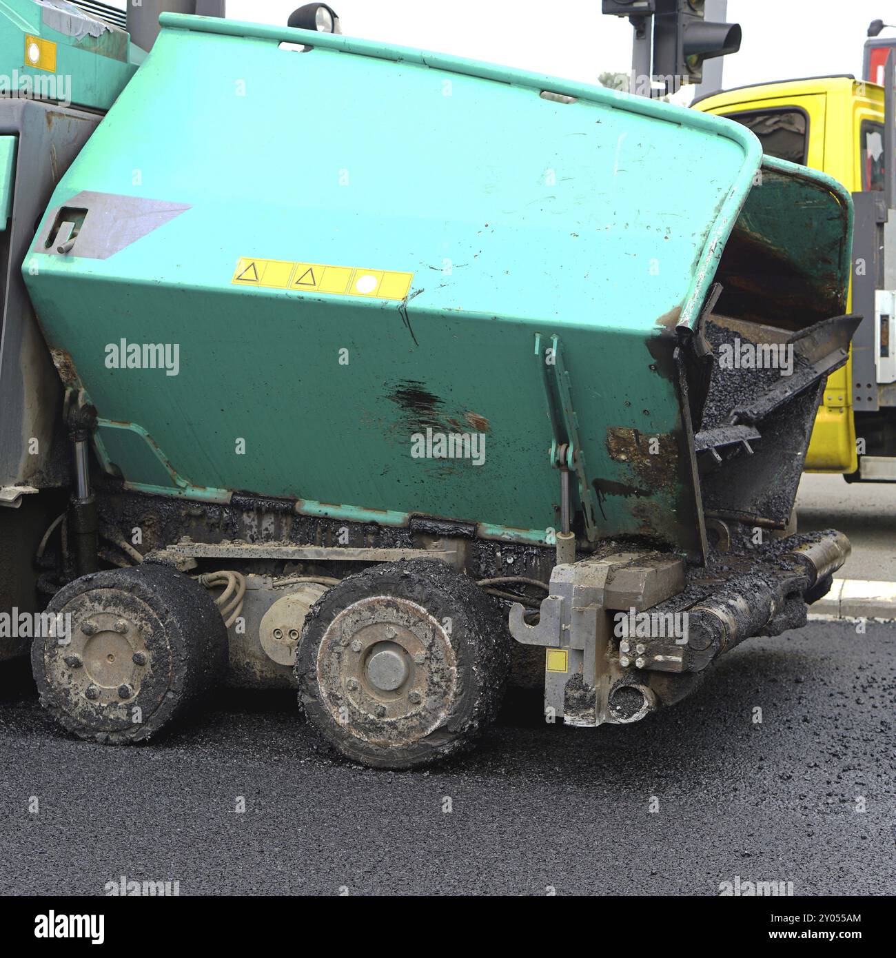 Asphalting works surfacing road machine Stock Photo - Alamy