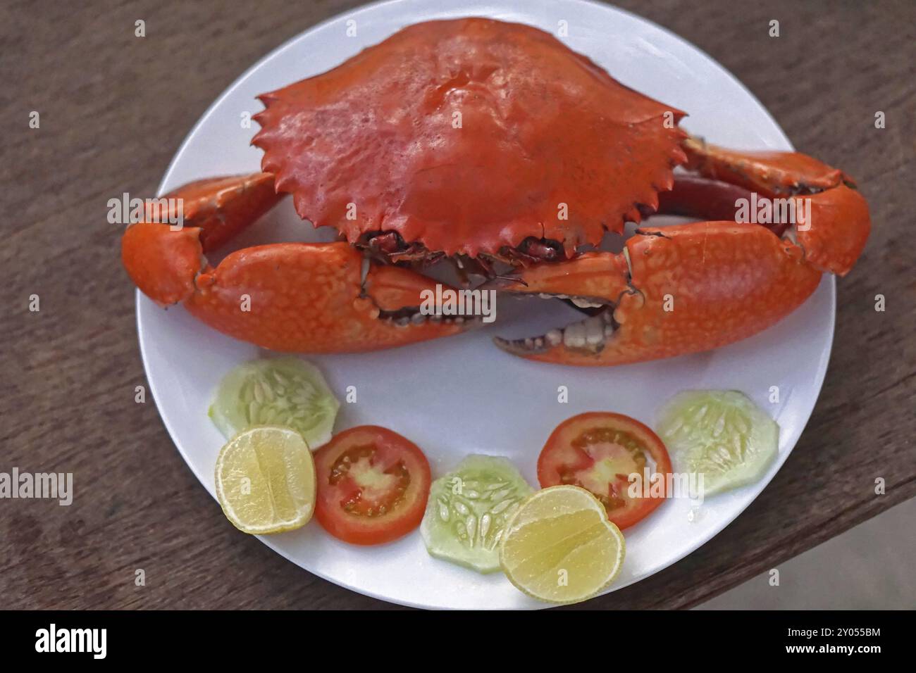 Orange cooked crab served at plate Stock Photo - Alamy