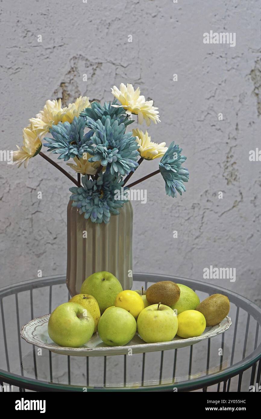 Flowers in vase and fruits at tray still life Stock Photo - Alamy