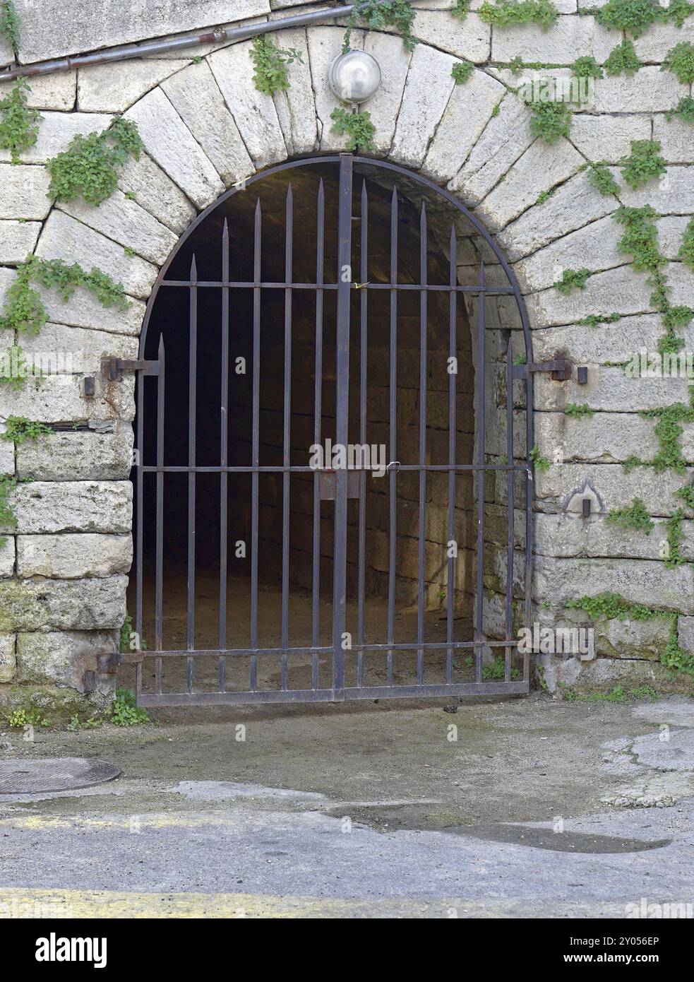 Stone arch doorway with iron bars door Stock Photo - Alamy
