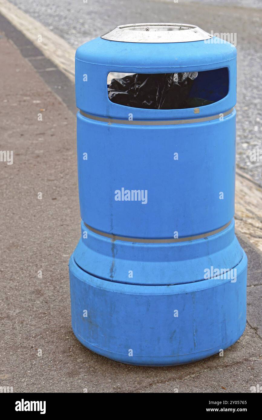 Blue plastic trash can at street Stock Photo - Alamy